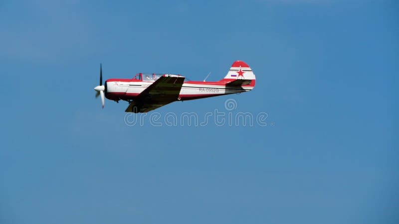 Propeller Plane with a Red Star Flies through the Sky at an Air Show ...