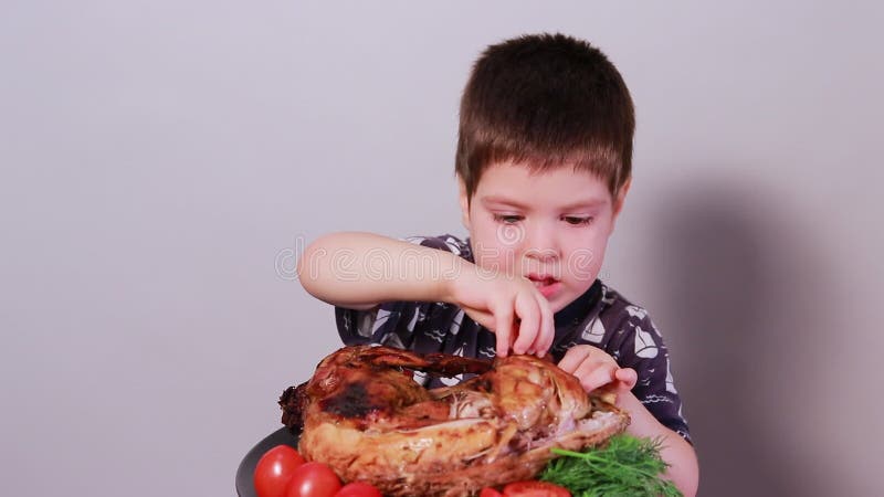 A Boy of 3-4 Years Old Eats Rabbit Meat. Proper Nutrition for Children ...