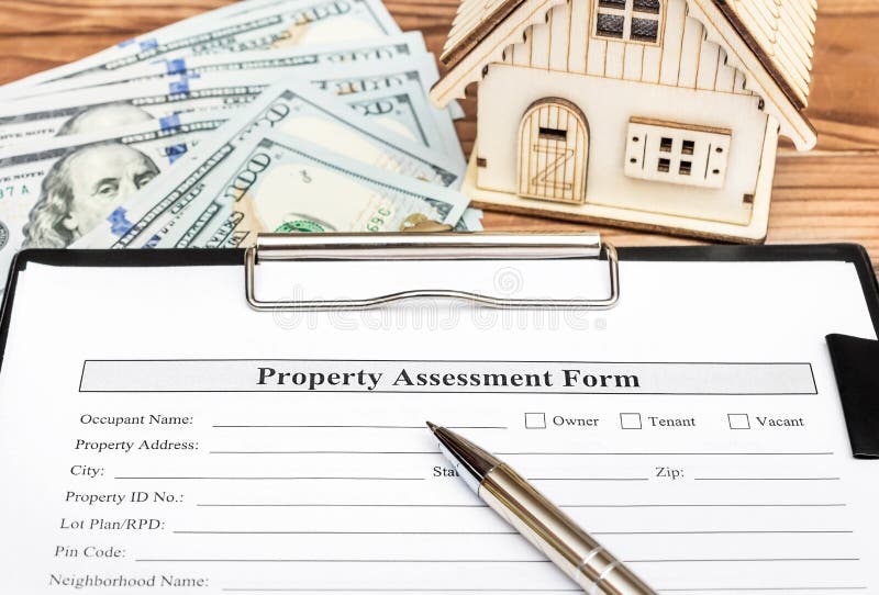 Property Assessment Form on Clipboard Over Table with Model of House ...