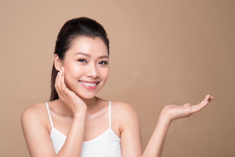 Proposing a Product. Beautiful Spa Woman Showing Empty Copy Space on ... Proposing a Product. Beautiful Spa Woman Showing Empty Copy Space on ...
