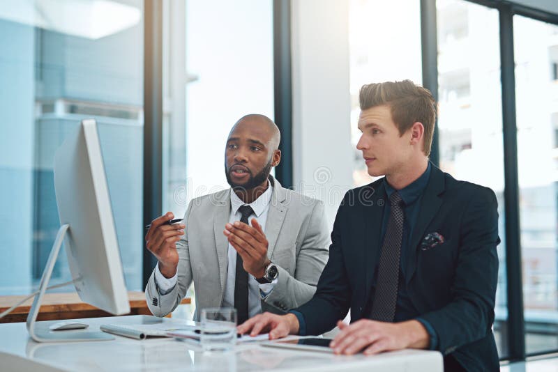 Proposing the Way Forward... Two Young Businessmen Having a Discussion ...