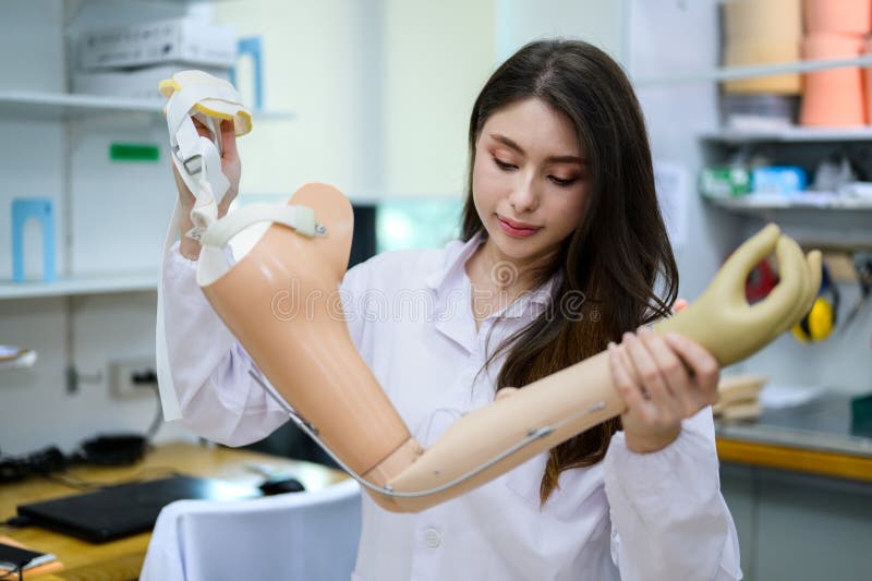 Prosthetic Technician Holding Prosthetic Arm Checking and Controlling ...