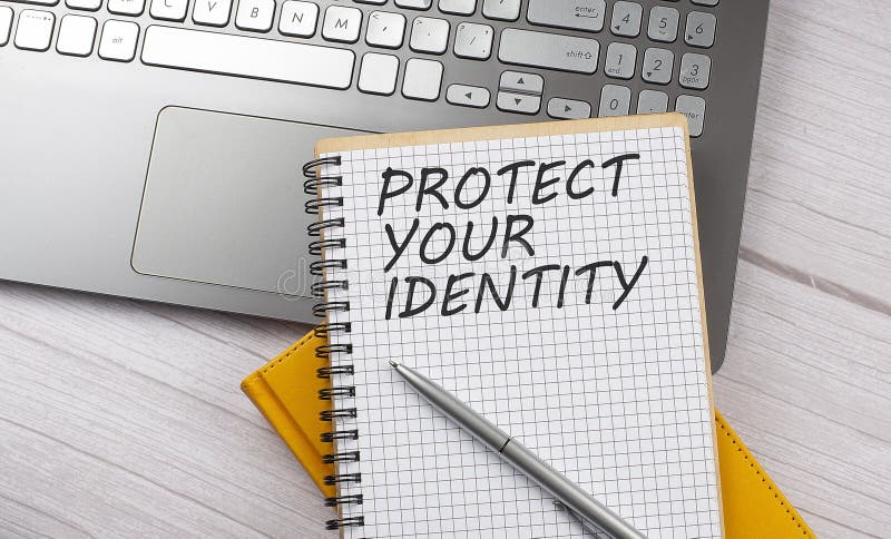 PROTECT YOUR IDENTITY Text Written on a Notebook on the Laptop Stock ...