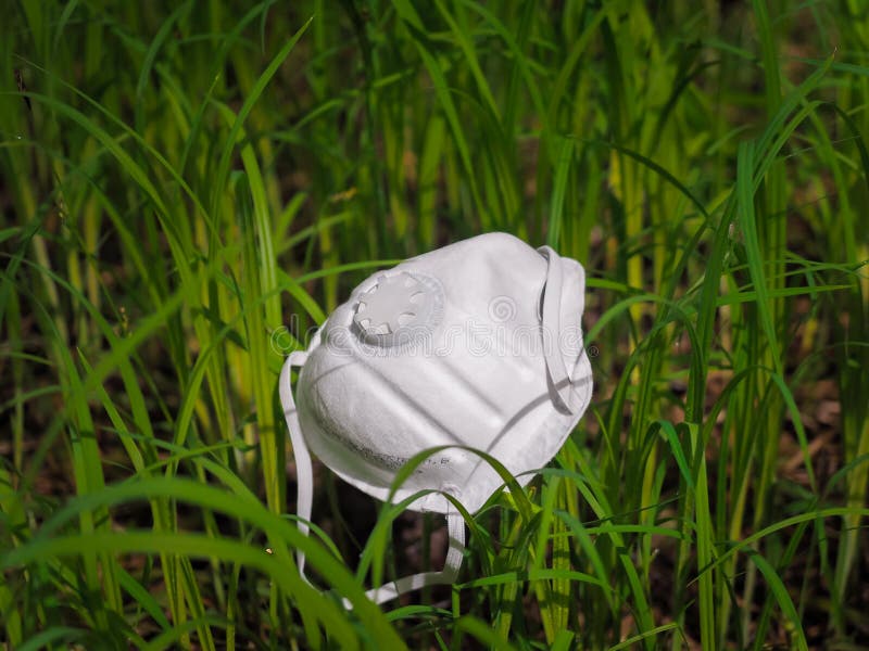 Protective Face Mask on the Grass in the Forest. during the Coronavirus ...
