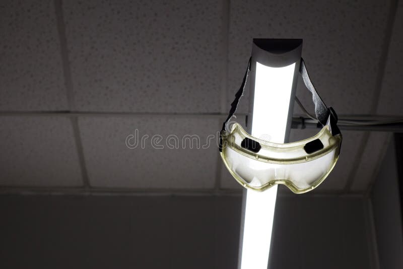 Protective Goggles for the Eyes Hanging on the Luminaire in a Hazardous ...