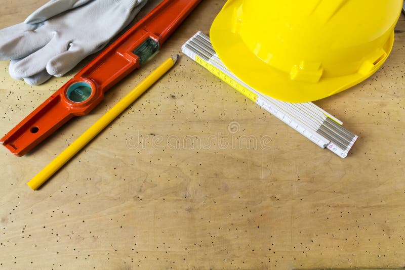 Protective Helmet, Mason Tools and Project Drawings on Wood Background ...