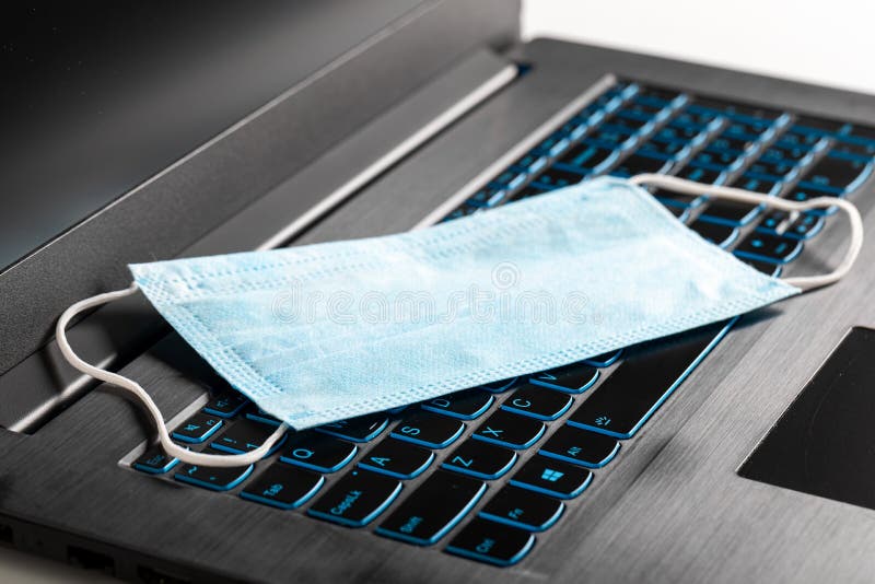 Protective Mask on Keyboard. Office Work from Home in Pandemic Stock ...