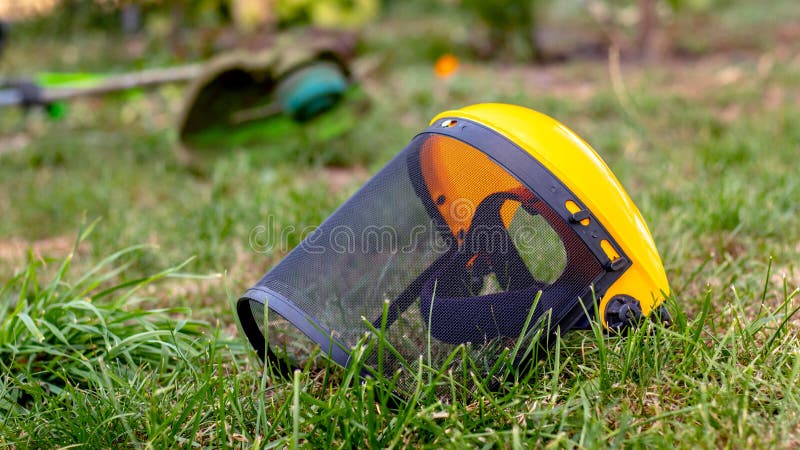 A Man With A Protective Mask For Safety While Mowing The Grass Stock ...
