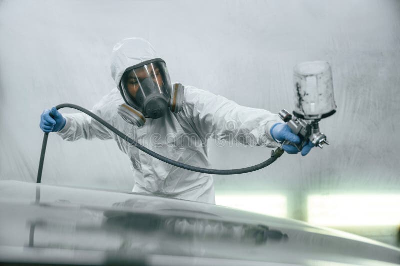 In Protective Mask and Wear. Close Up View of Man that is Painting a ...