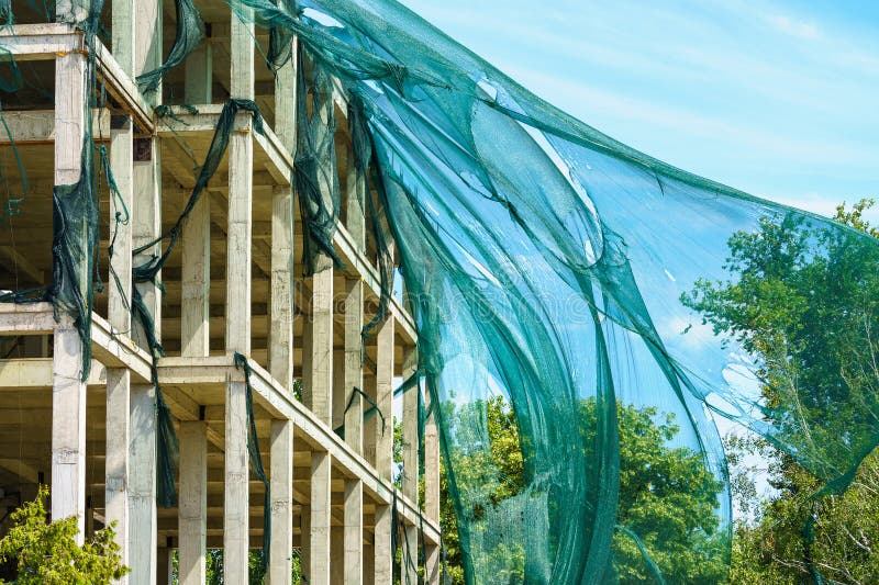 Protective Mesh on Scaffolding Torn by Hurricane Wind. Background with ...