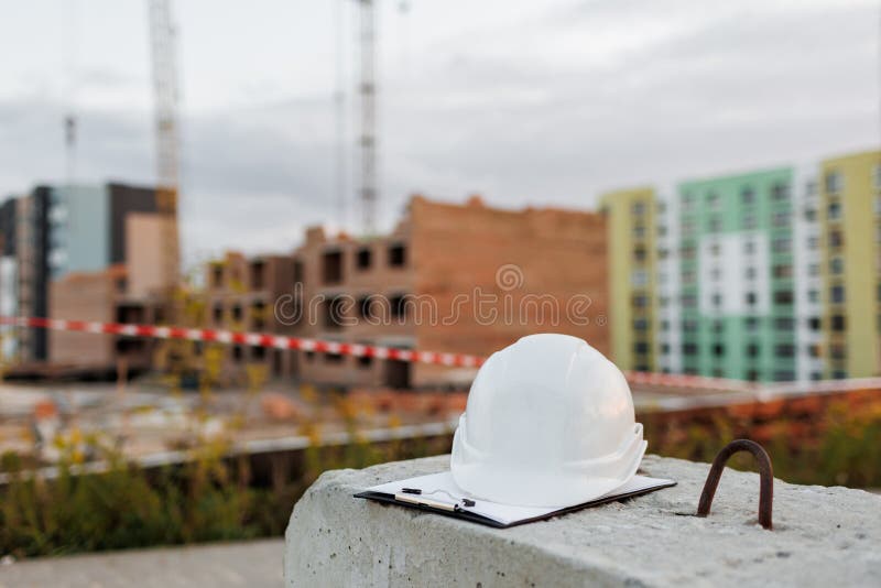 Protective White Hard Hat and Clipboard Folder of Engineer on Concrete ...