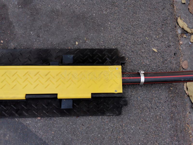 Protector on the Ground.Black and Yellow Wire Cable. Floor Cable ...