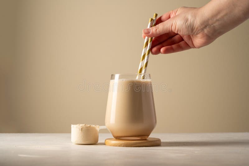 Protein Powder and Chocolate Drink in a Glass with Straw, Copy Space ...
