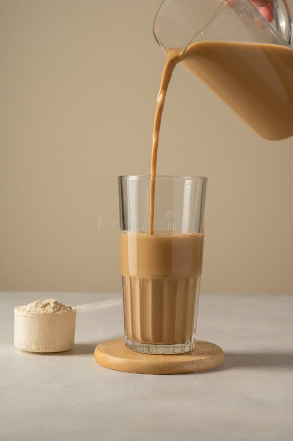 Protein Powder and. Pouring Chocolate Drink in a Glass. Stock Image ...