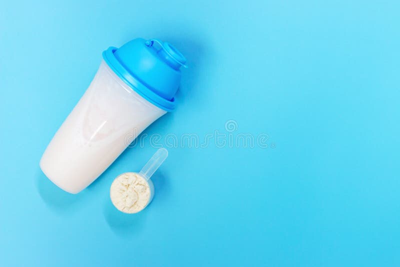 Protein Shake and Measuring Spoon with Powdered Protein on Blue ...