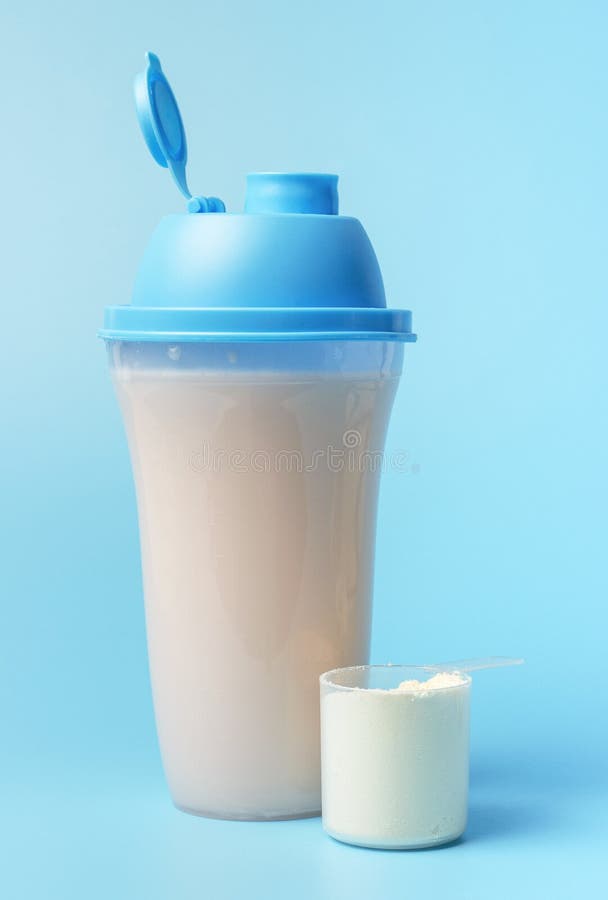 A Protein Shake and a Scoop on Blue Background, Front View Stock Photo ...