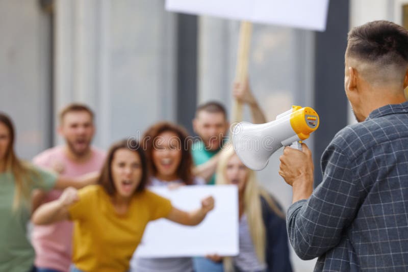 Protest Leader with Megaphone Talking To Crowd Outdoors Stock Image ...