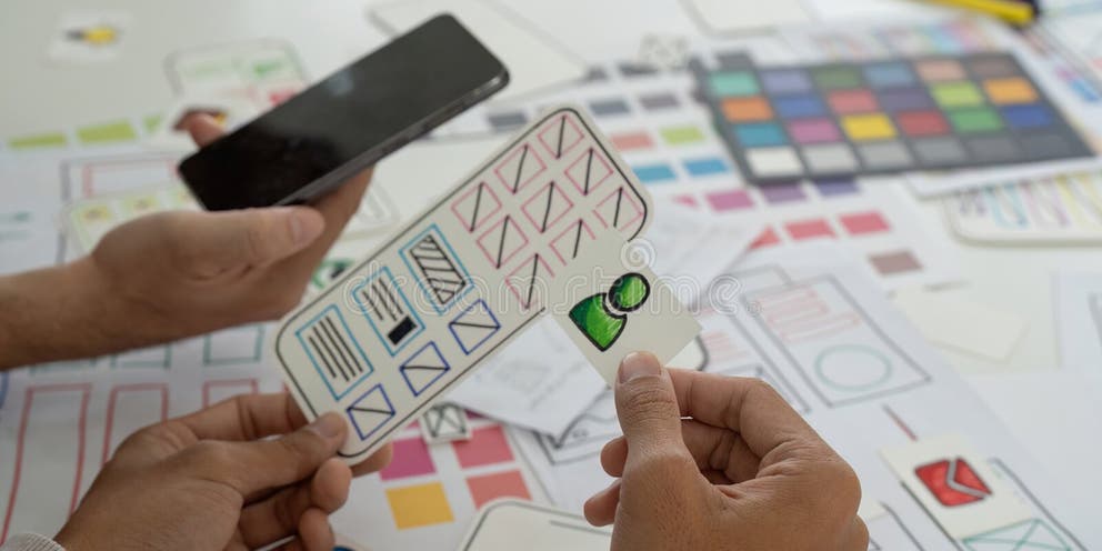Prototyping and Mobile App Design. Collaborators Analyzing Wireframes ...
