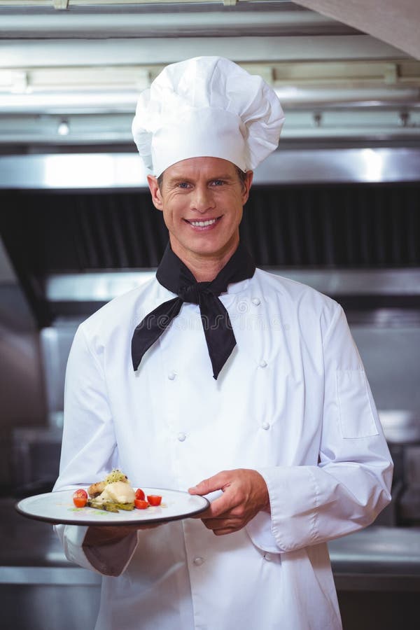 Proud chef holding a plate stock photo. Image of hotel - 68241164