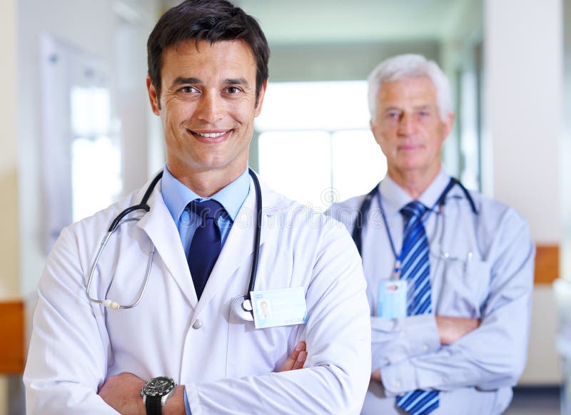 Proud of His Private Practice. Portrait of Two Smiling Doctors Standing ... Proud of His Private Practice. Portrait of Two Smiling Doctors Standing ...