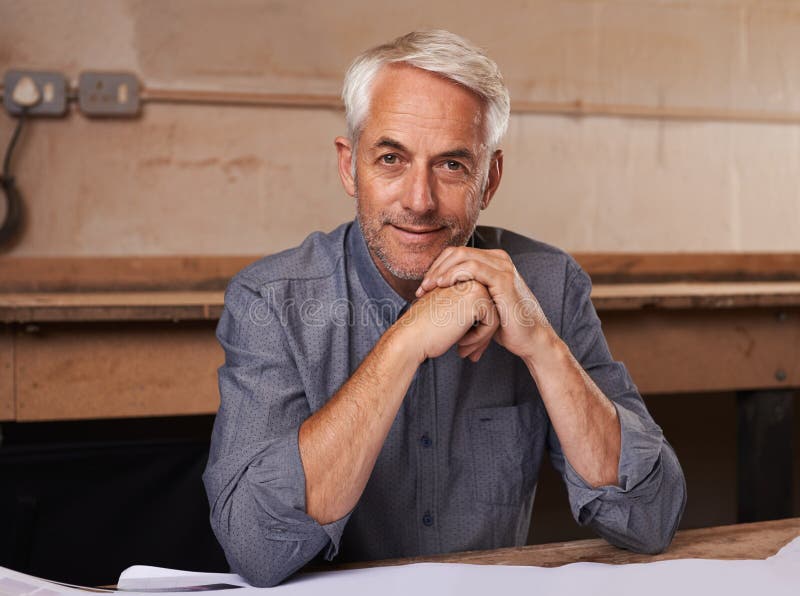 Proud of His Workshop. Portrait of a Senior Man Sitting at His Desk in ...