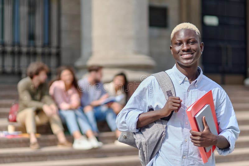 Proud Student with a Textbook Standing in Front of the University ...