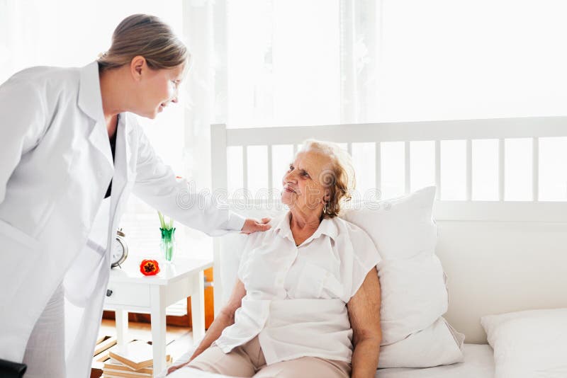 Providing Care for Elderly. Doctor Visiting Elderly Patient at Home ...