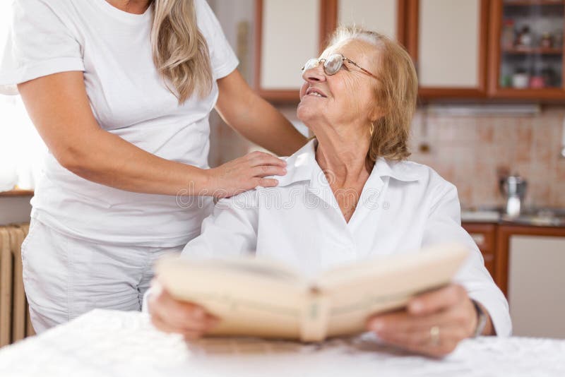 Providing care for elderly stock image. Image of caregiver - 141271619
