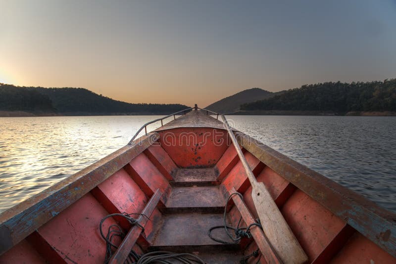 Prow boat on lake stock photo. Image of mountain, sunset - 207079688