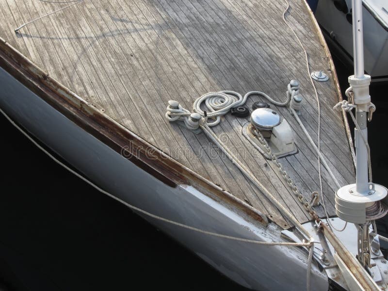 Prow of Sailboat Moored in the Harbor with Wooden Deck in Foreground ...