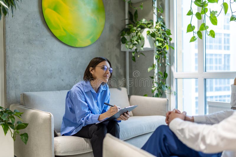 Psychologist Having a Sessiona with a Couple and Making Notes Stock ...