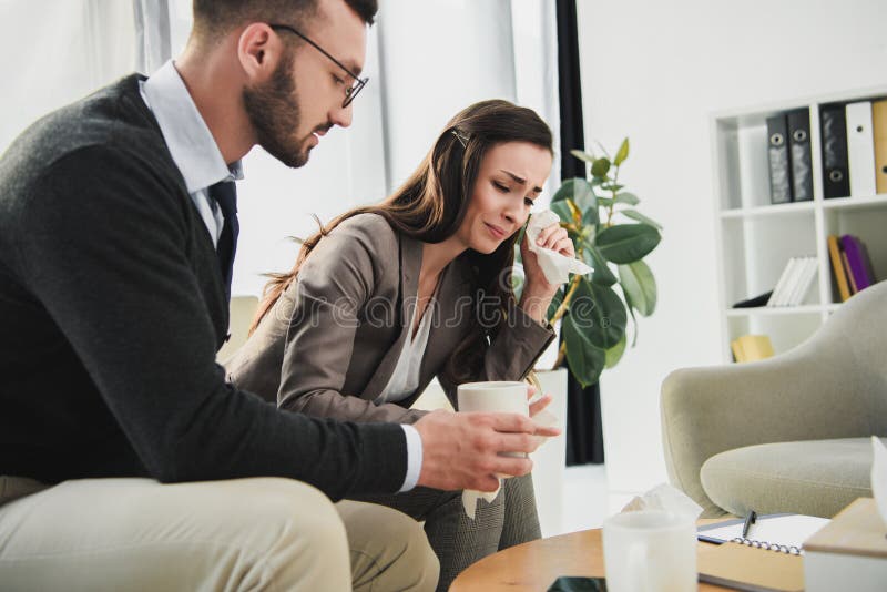 Psychologist Giving Cup of Tea To Crying Patient Stock Photo - Image of ...