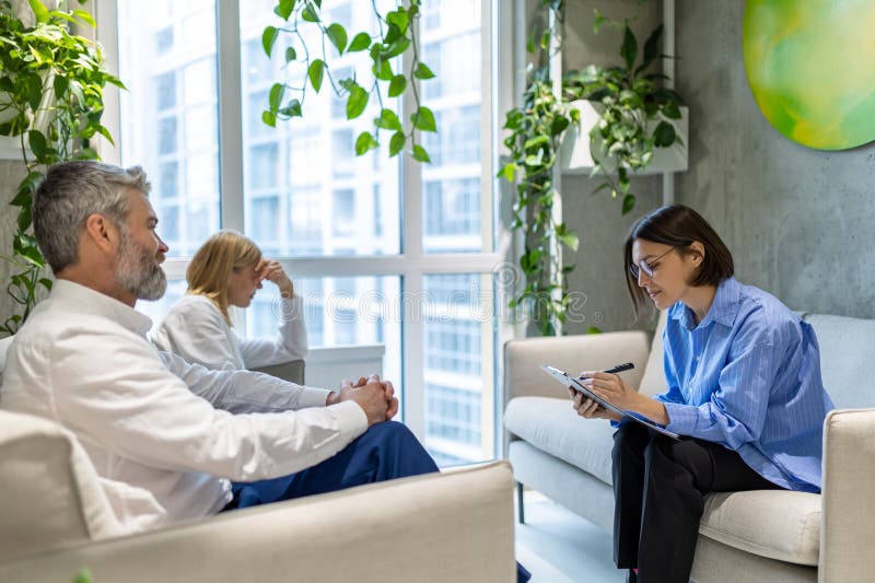 Psychologist Having a Sessiona with a Couple and Making Notes Stock ...