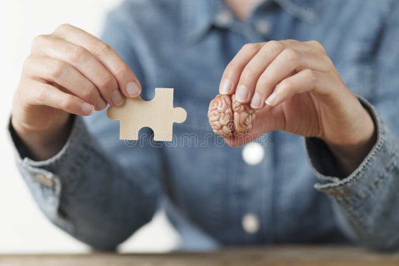 A Psychologist is Holding Human Brain and Puzzle. Problem Solving, Help ...