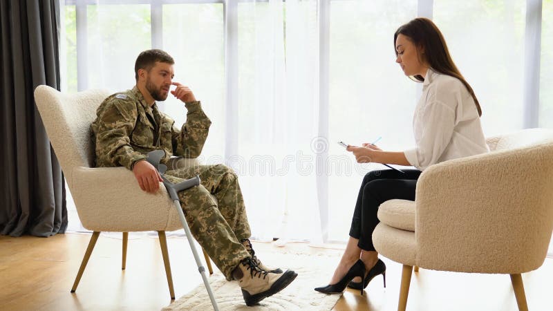 Psychologist Making Notes during Therapy Session with Sad Male Soldier ...