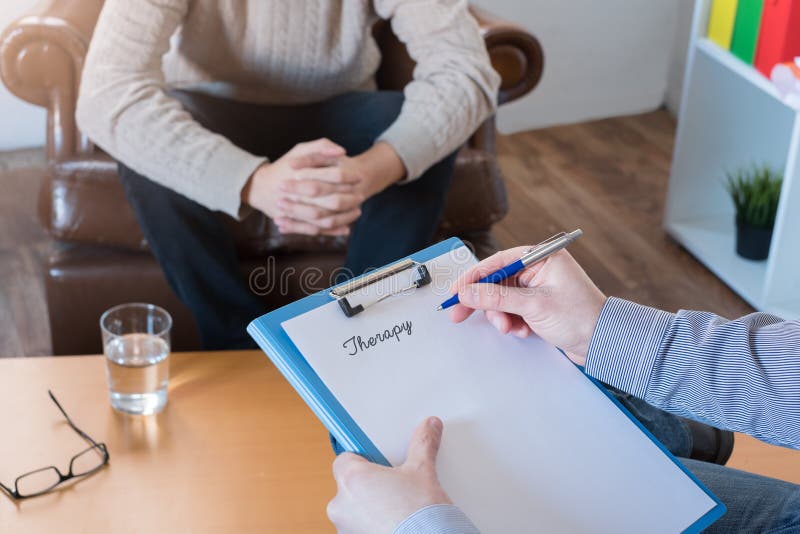 Psychologist Writing Notes during a Therapy Session with Patient Stock ...
