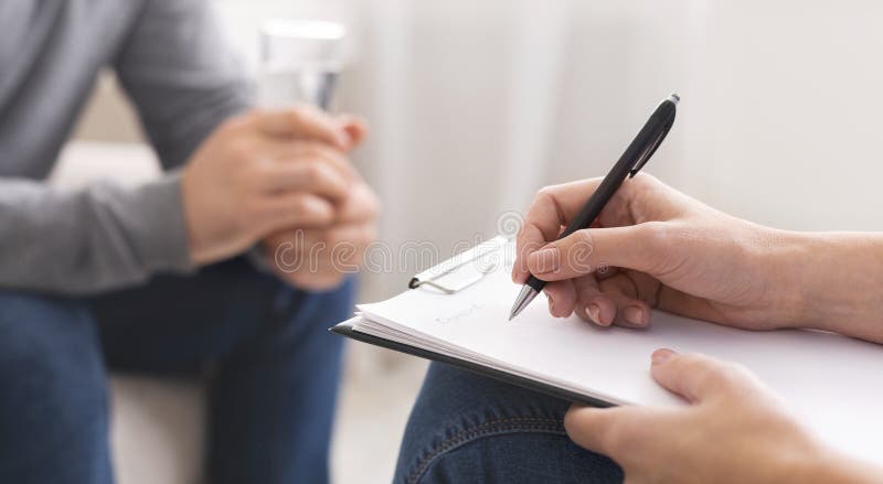 Psychologist Writing Notes during a Therapy Session with Patient Stock ...