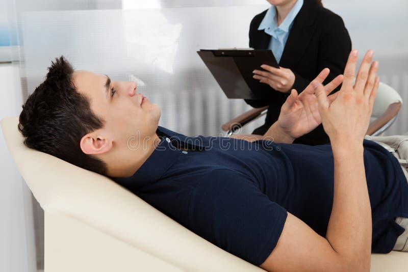 Psychologist Writing Notes while Patient Lying on Bed Stock Image ...