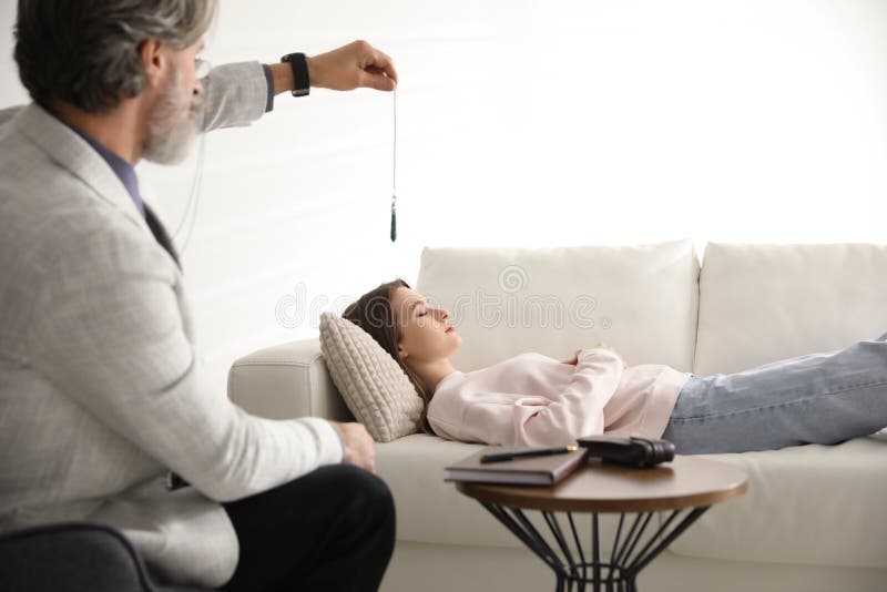 Psychotherapist Using Pendulum during Hypnotherapy Session Stock Photo ...