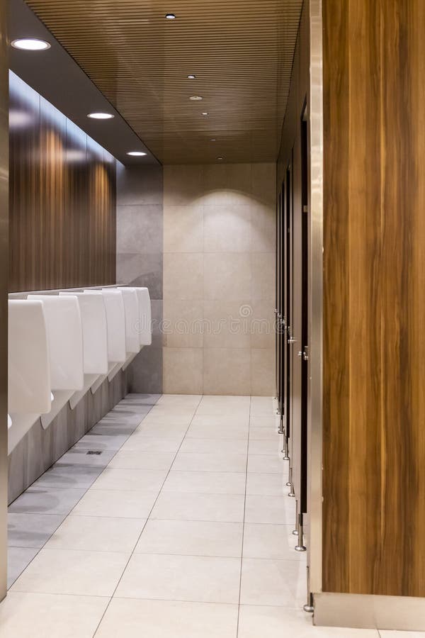 Public Empty Mens Restroom with Urinals and Cabins Stock Image - Image ...