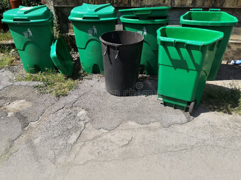 The Public Green Garbage Bins Empty and Damaged on the Ground Stock ...