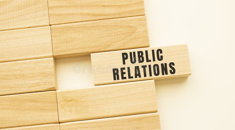 PUBLIC RELATIONS Text on a Strip of Wood Lying on a White Table. Stock ...