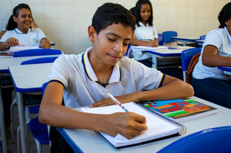 Public School Student in the Classroom Writing in the Notebook ...