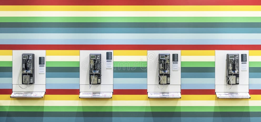 Public Telephone by the Colorful Wall Editorial Photography - Image of ...