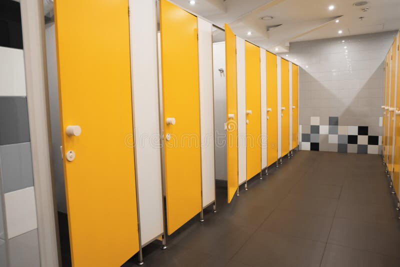 Public Toilet Interior with Bright Yellow Stalls Stock Image - Image of ...