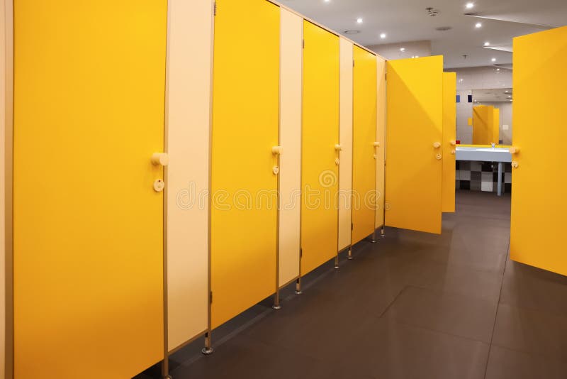 Public Toilet Interior with Bright Yellow Stalls Stock Photo - Image of ...