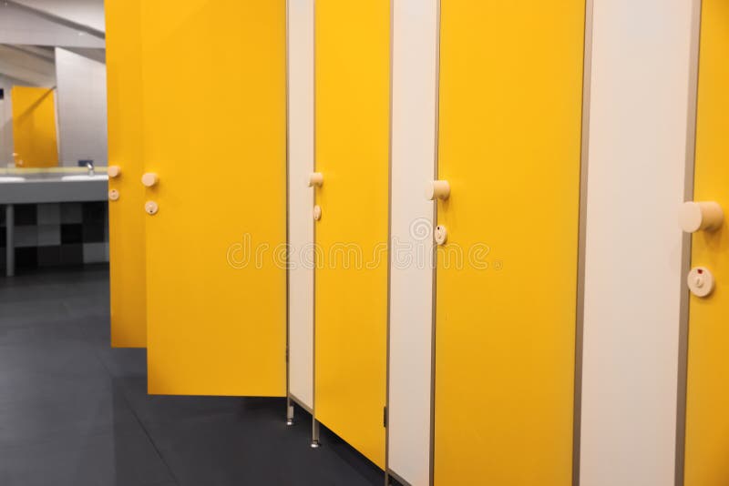 Public Toilet Interior with Bright Yellow Stalls Stock Photo - Image of ...