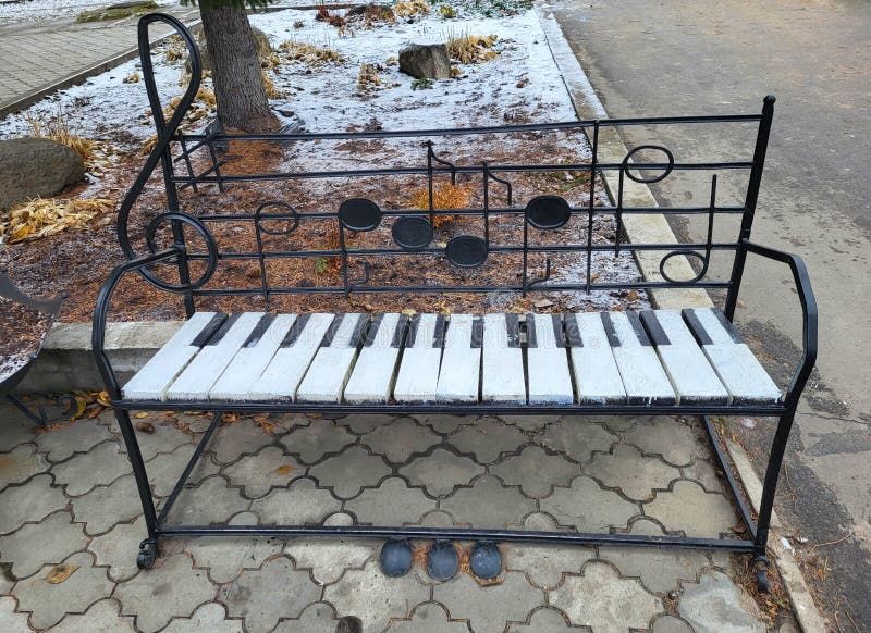 In a Public Urban There is a Bench in the Park, a Backrest, a Musical ...
