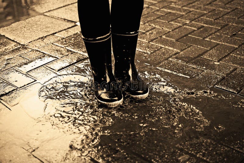 In a puddle stock photo. Image of boots, drips, waterproof - 22353718