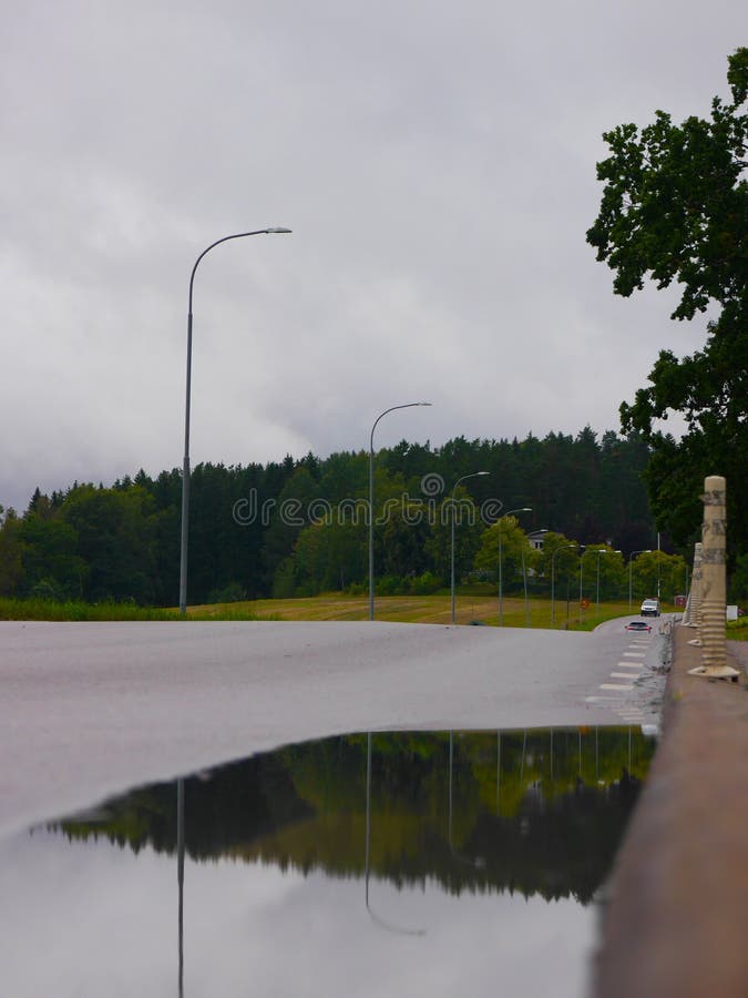 A puddle on asphalt road stock photo. Image of country - 290245738